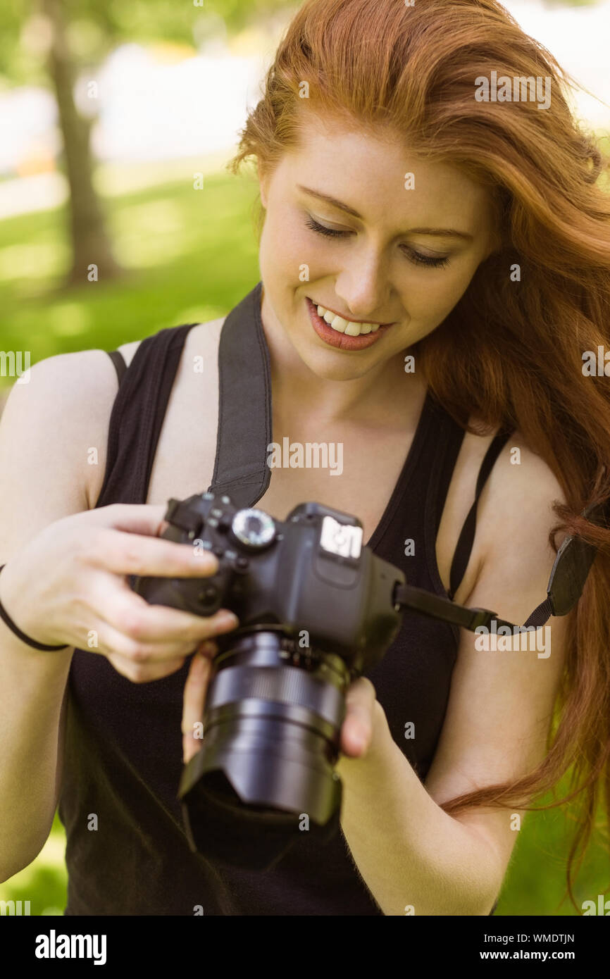 Portrait of beautiful female photographer at the park Stock Photo - Alamy