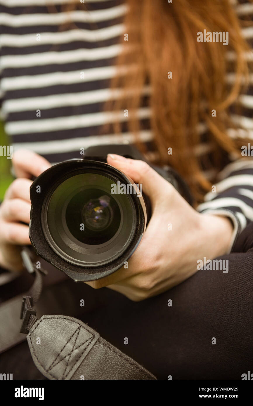 Close up mid section of female photographer with dslr camera Stock ...