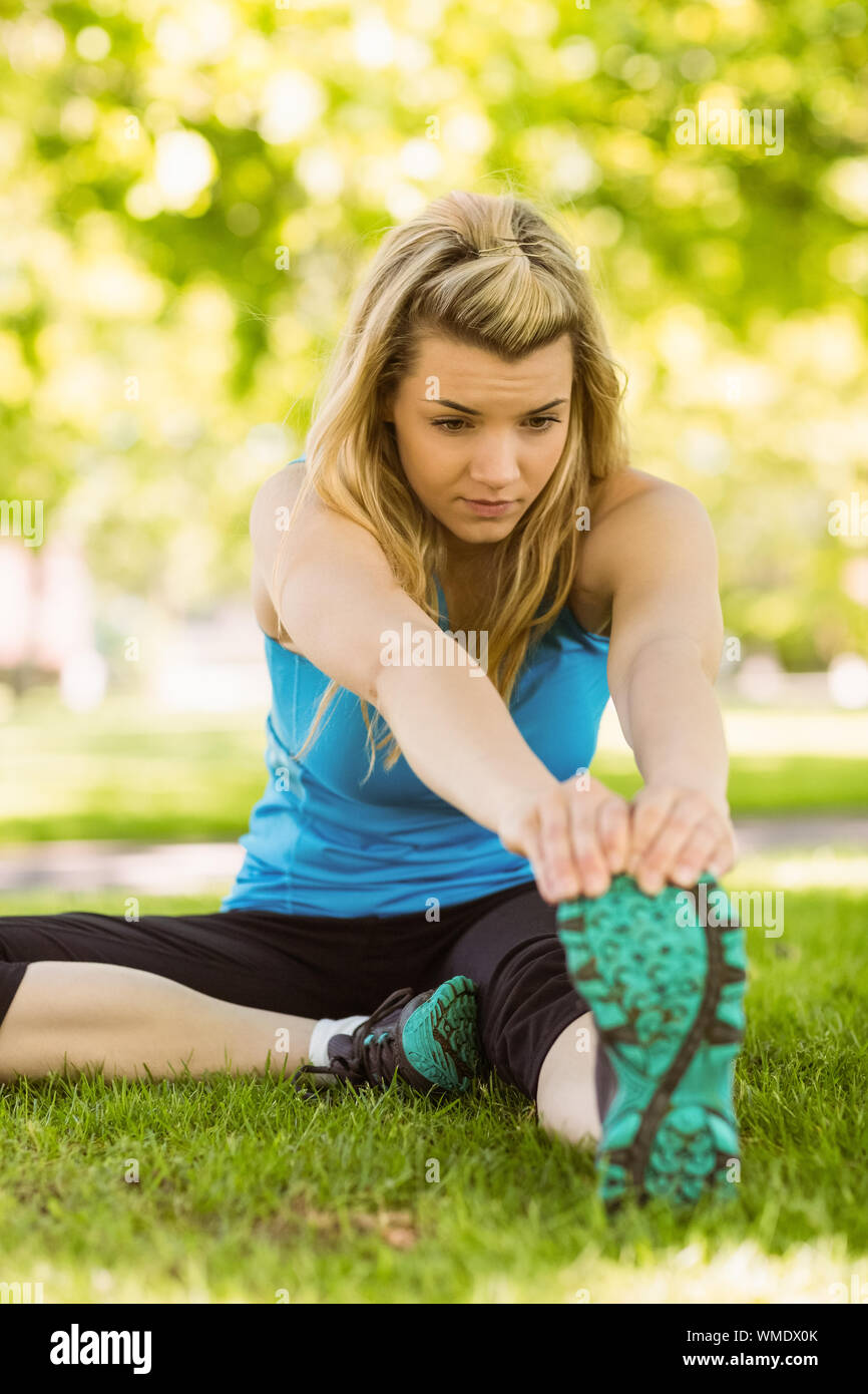 Fit blonde stretching on grass hi-res stock photography and images - Alamy