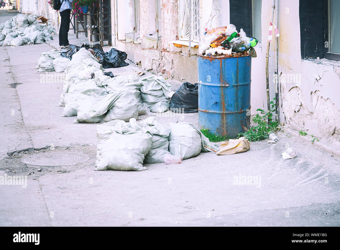 Garbage in bags and barrels on the streets Stock Photo - Alamy