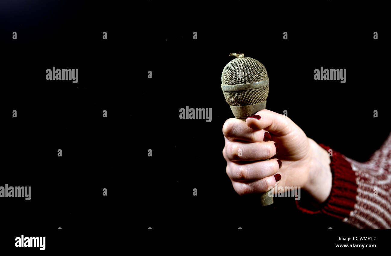 Black hand holding microphone hi-res stock photography and images - Alamy