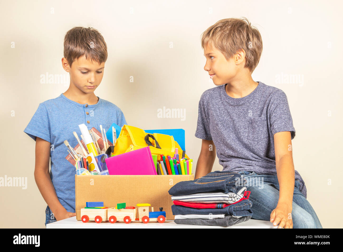 Donation concept. Kids with donate box with books and school supplies ...