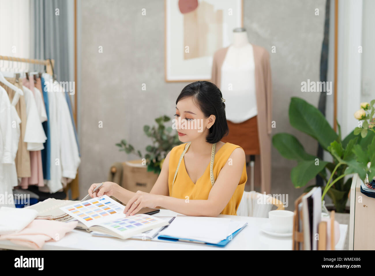 A young fashion designer working on her atelier Stock Photo - Alamy