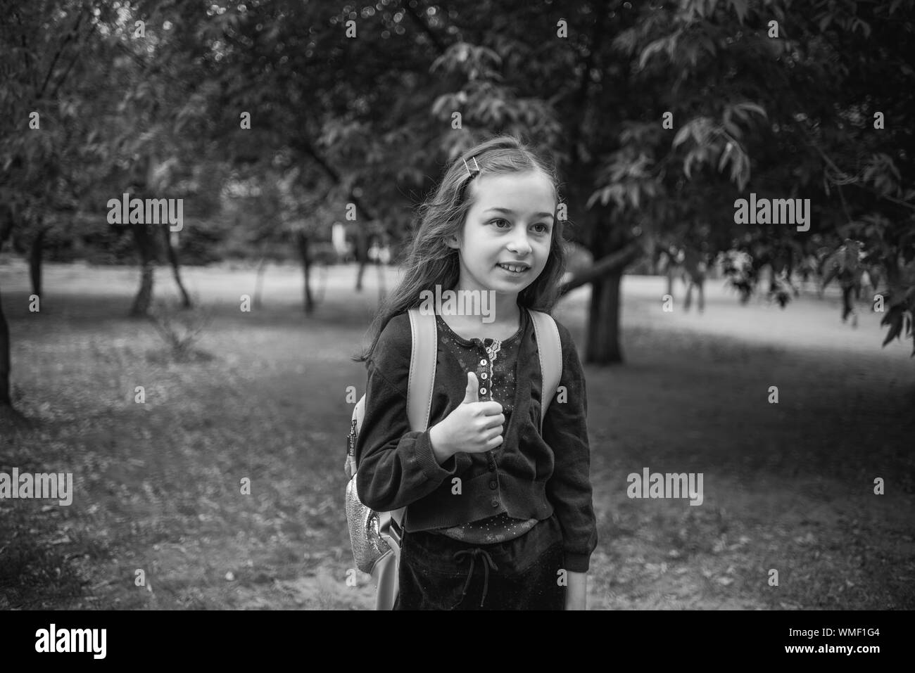 Girl on a background of nature.Shy teenager in the sun. Schoolgirl with ...