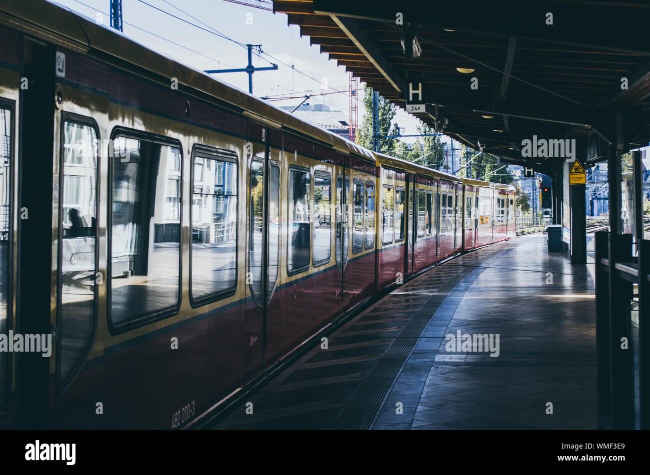 Wide shot of a red and yellow train in a train station Stock Photo - Alamy