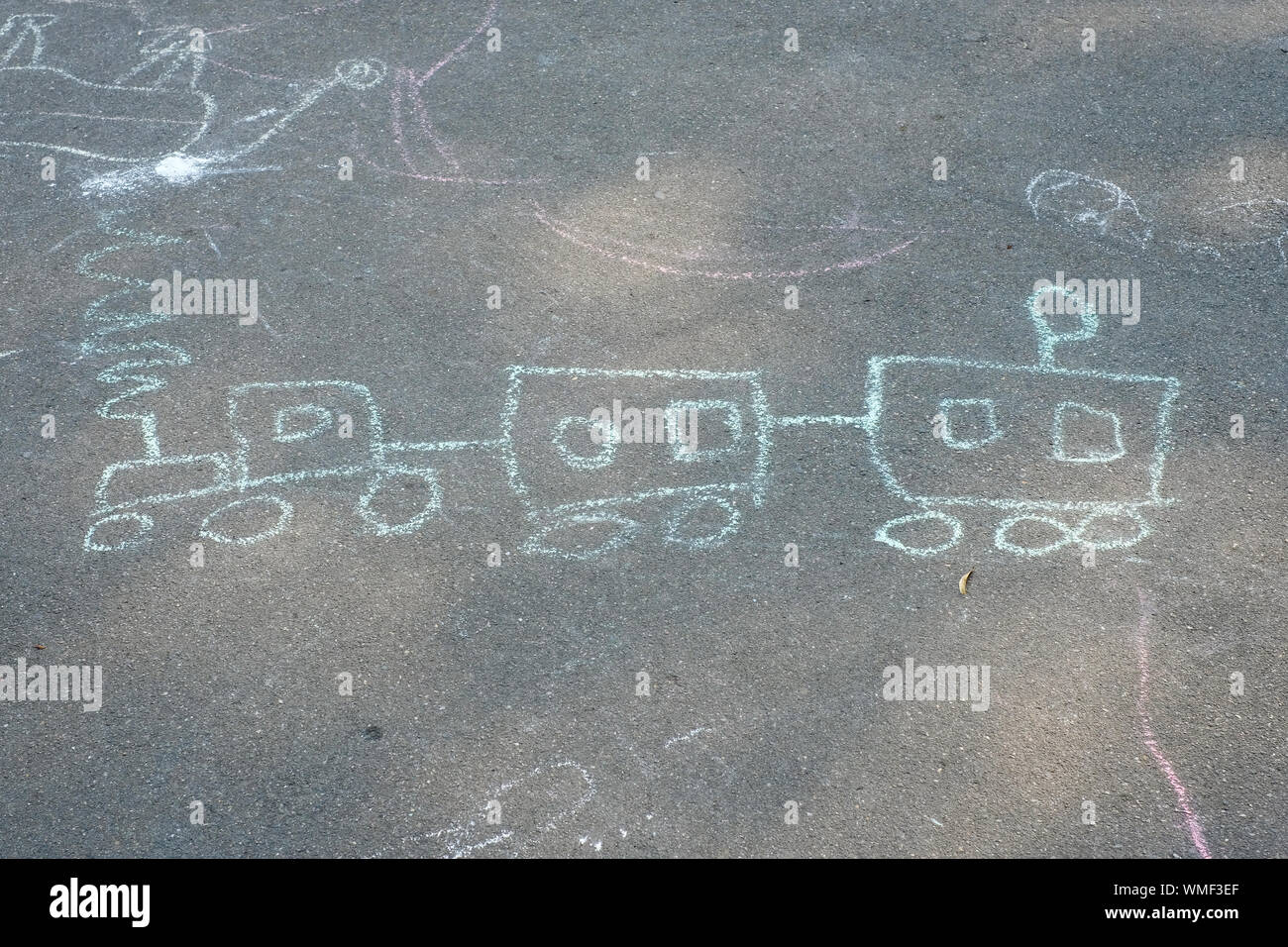 Chalk drawing of train on asphalt. Children's creativity in the summer ...