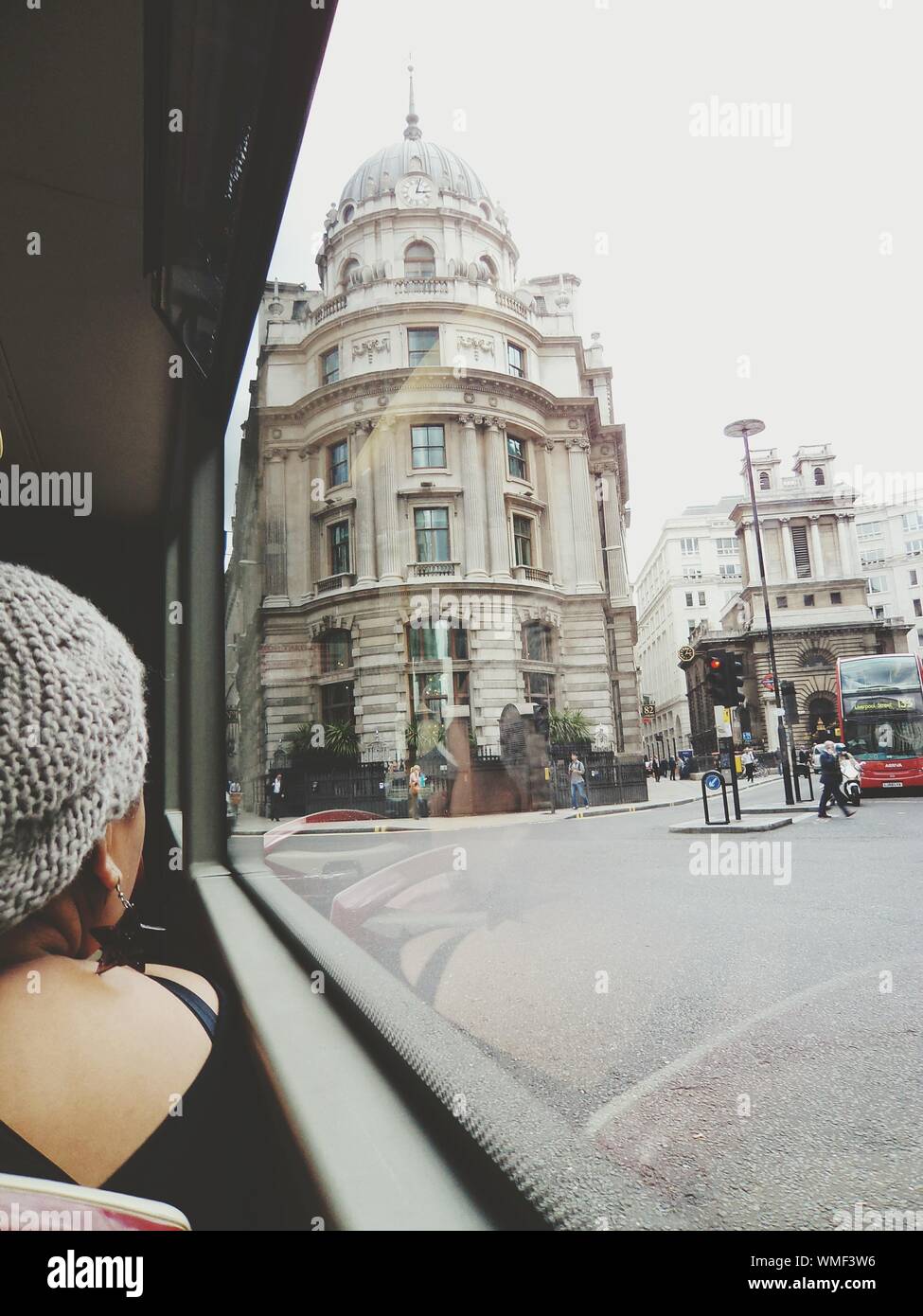 Woman looking at city view from window hi-res stock photography and ...