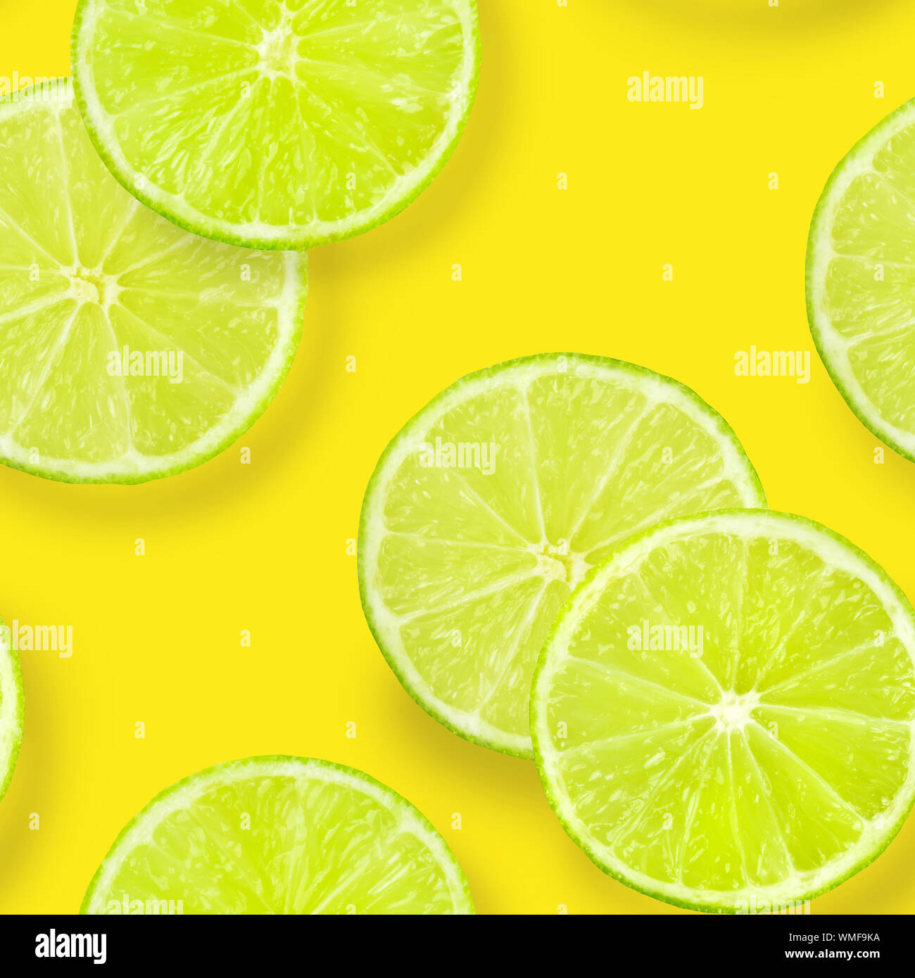 A seamless pattern of lime slices on a vibrant yellow background, a ...