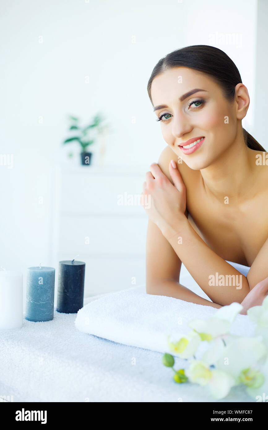 Spa treatments.Beautiful Woman In A Spa Salon. Relax and skin Cleansing. Woman Lying on a Bed in ...