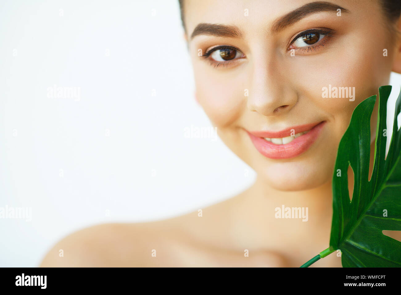 Skin Care. Beautiful Girl with Green Leaves. Beauty Treatment ...