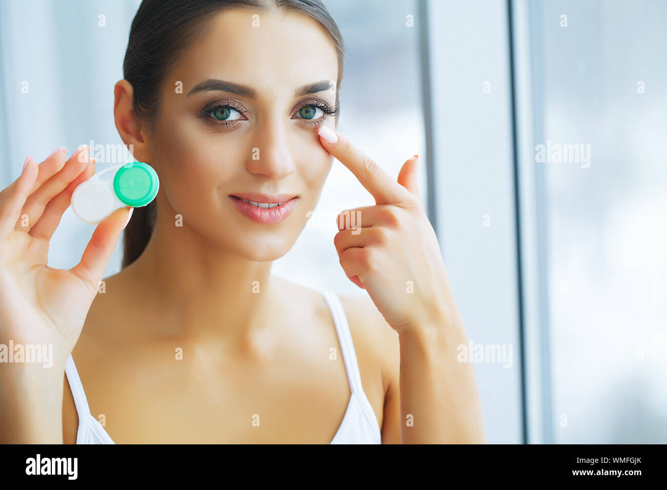 Health. Young Girl Holds Contact Lens In Hands. Portrait of a Beautiful ...