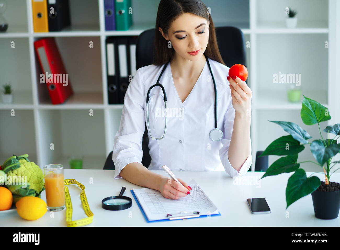 Health. The doctor signs out a diet plan. The Dietitian Holds in the ...
