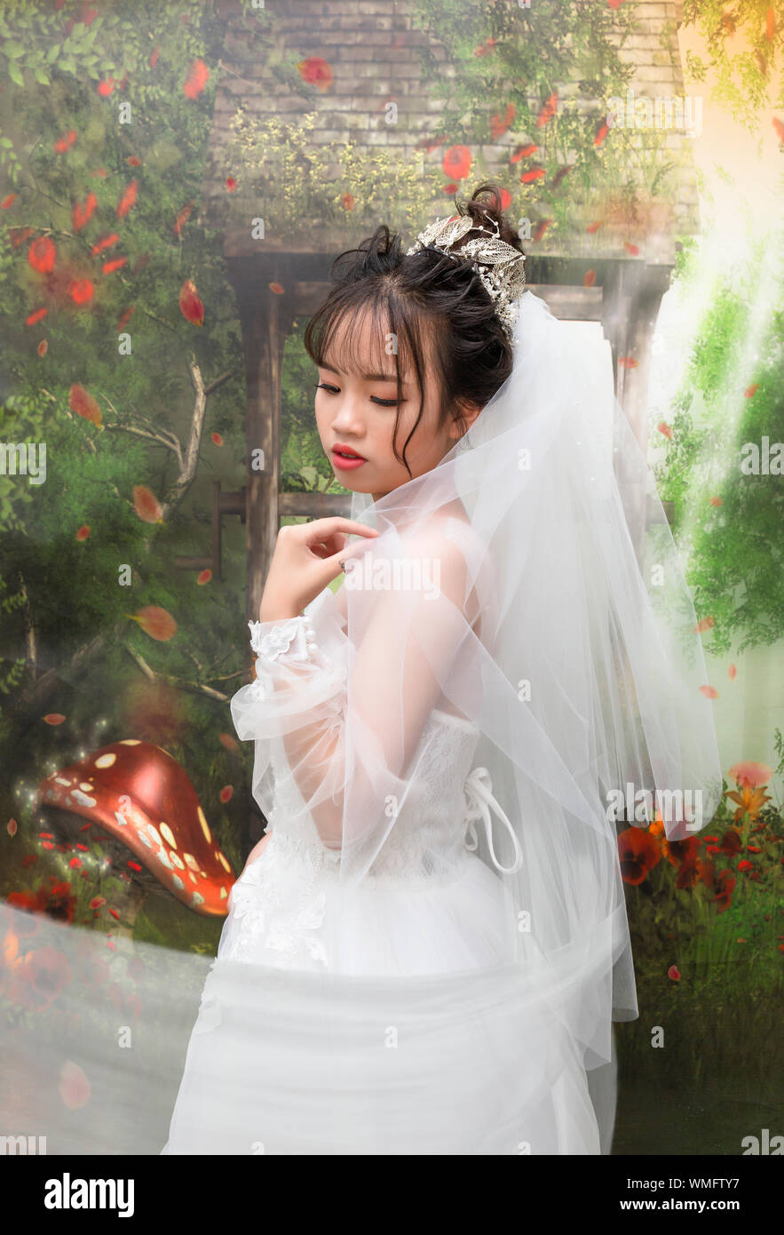 the beautiful girl in the bride dress, the woman and the red rose are ...