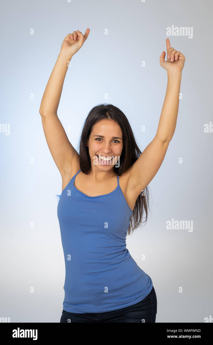 Portrait of young attractive woman celebrating success winning or ...