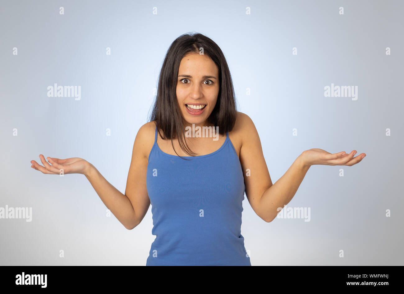 Portrait of Attractive latin young woman making clueless gesture having ...