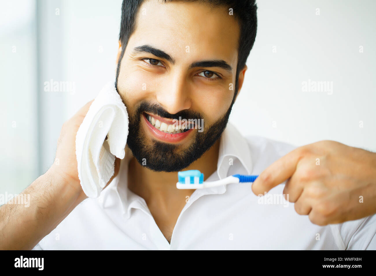 Beautiful Smiling Man Brushing Healthy White Teeth With Brush. High ...