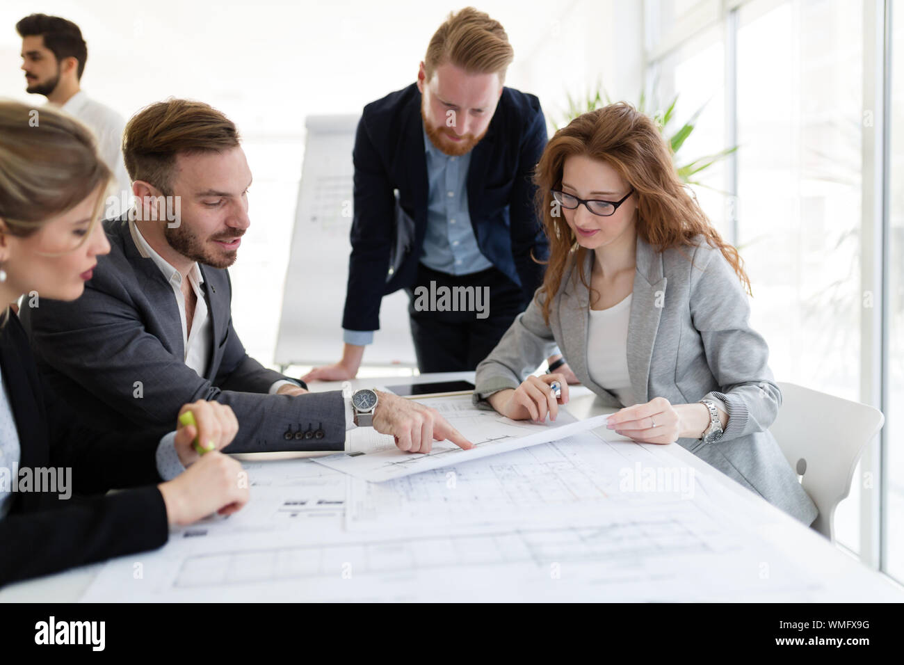 Team of architects working together on project Stock Photo - Alamy