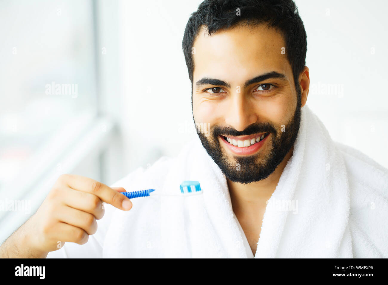 Beautiful Smiling Man Brushing Healthy White Teeth With Brush. High ...