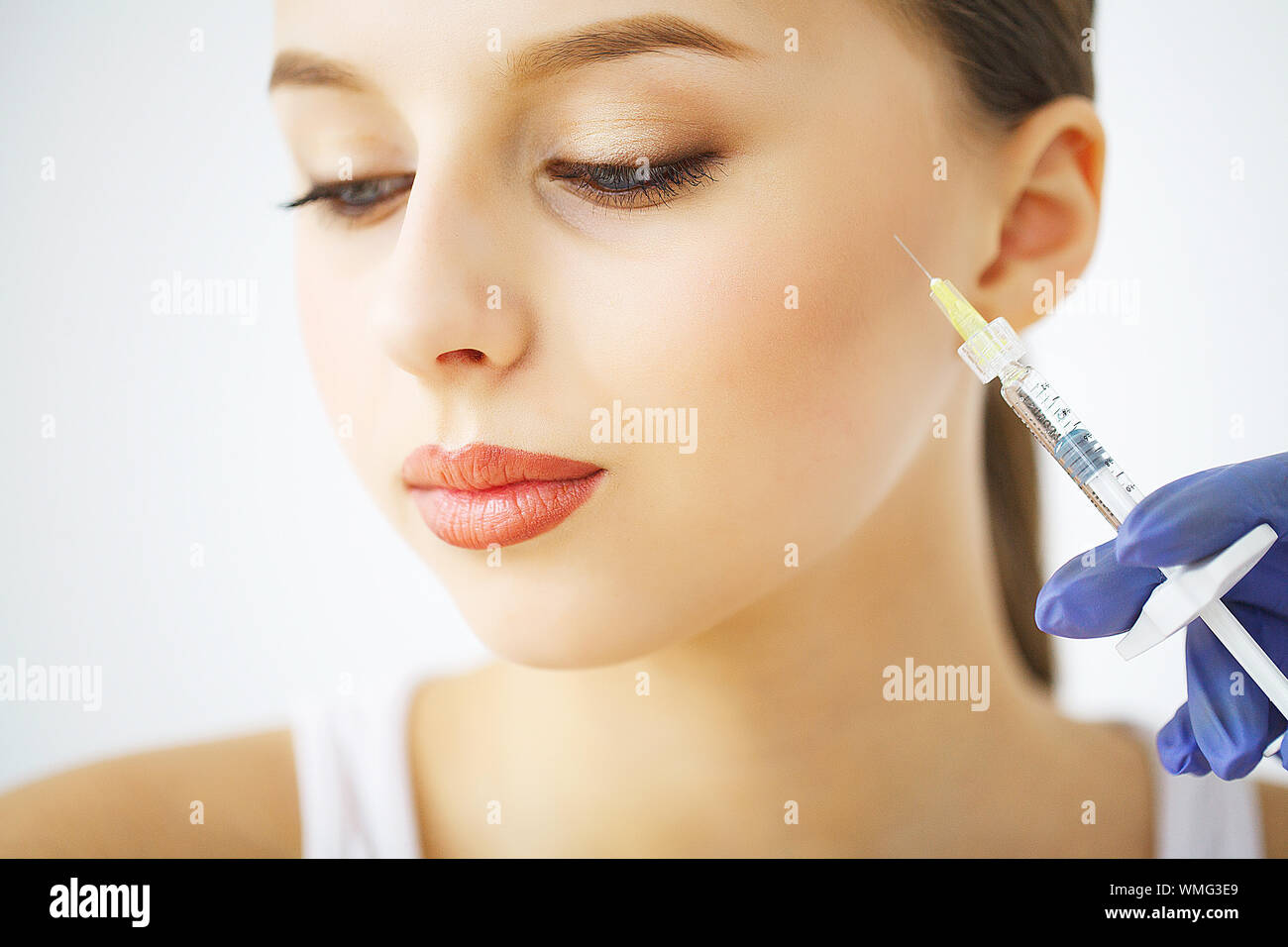 Lips plastic surgery injection on young woman face Stock Photo - Alamy