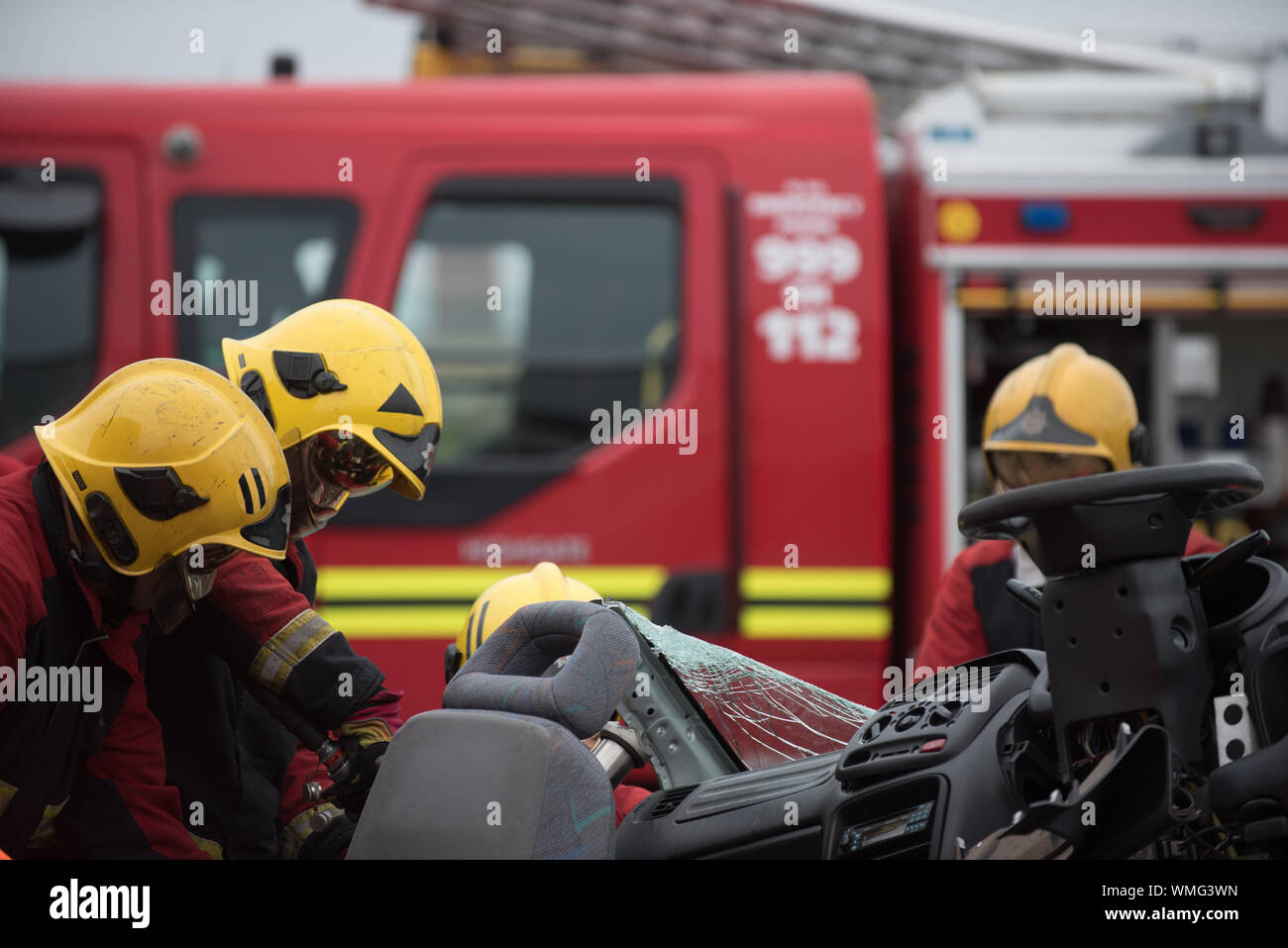 Firemen at the scene of a car crash Stock Photo - Alamy