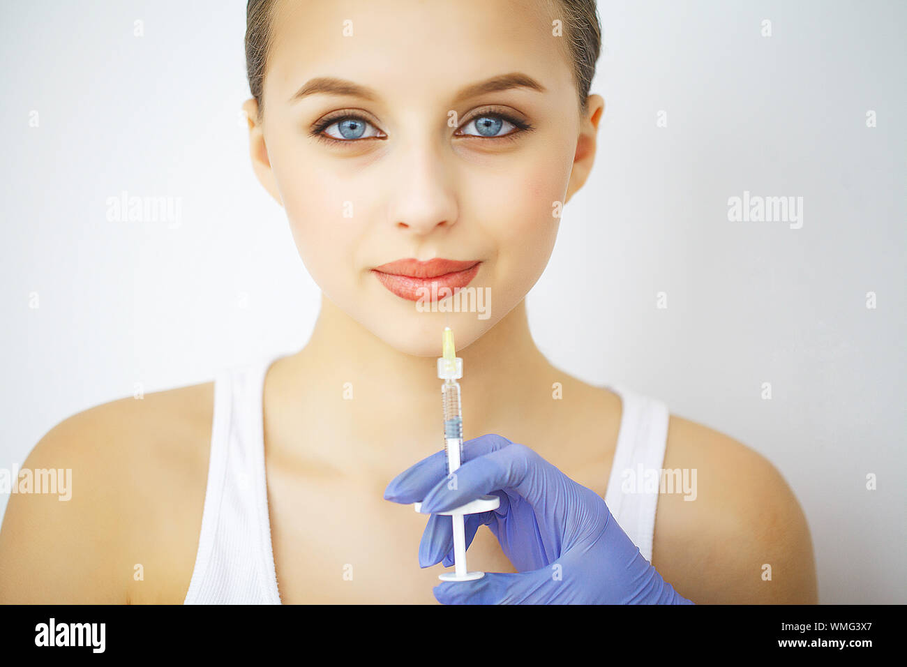 Lips plastic surgery injection on young woman face Stock Photo - Alamy