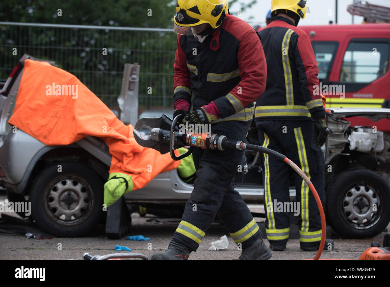 Firemen at the scene of a car crash Stock Photo - Alamy