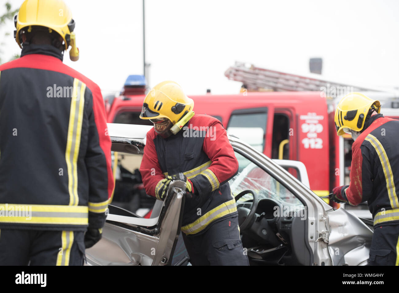 Firemen at the scene of a car crash Stock Photo - Alamy