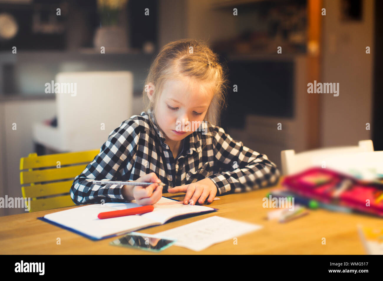 Cute Girl Studying At Table Stock Photo - Alamy
