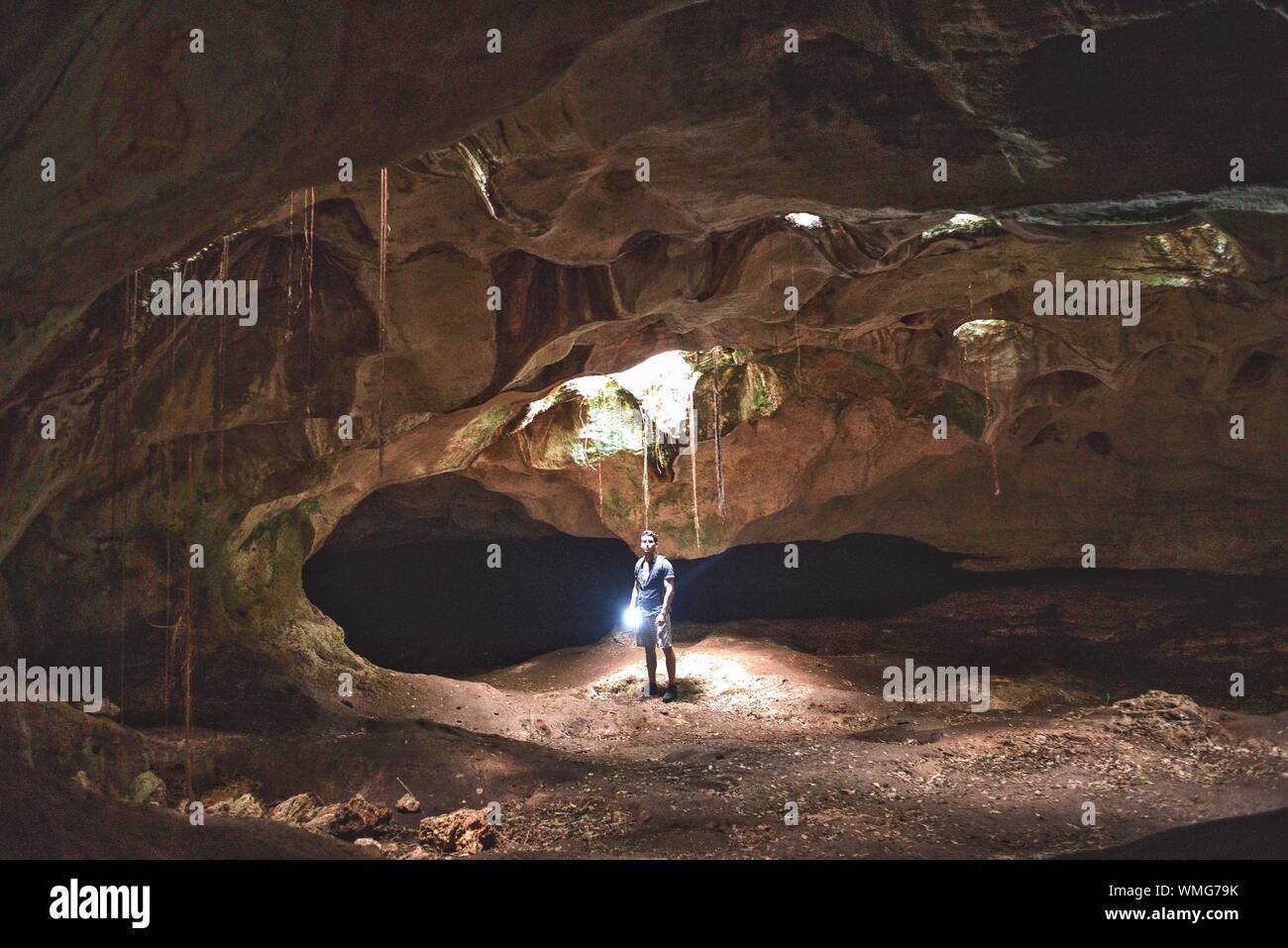 Man standing in cave hi-res stock photography and images - Alamy