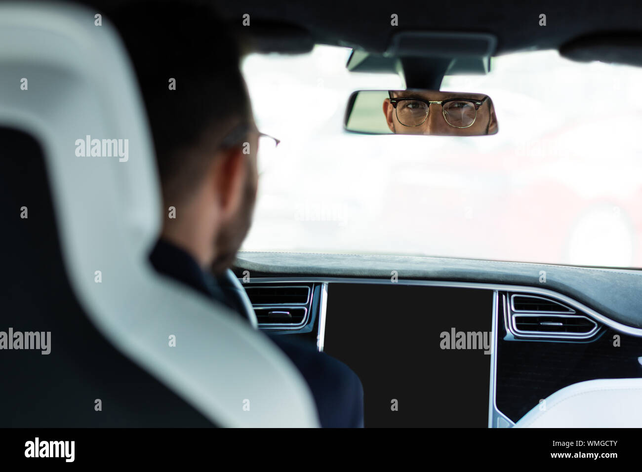 Man driving car looking back hi-res stock photography and images - Alamy