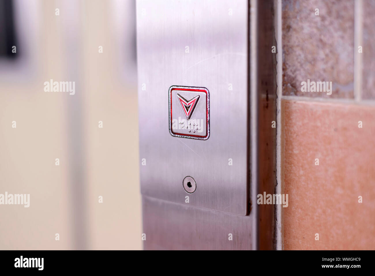 Close-up Of Down Arrow Elevator Button On Wall Stock Photo - Alamy
