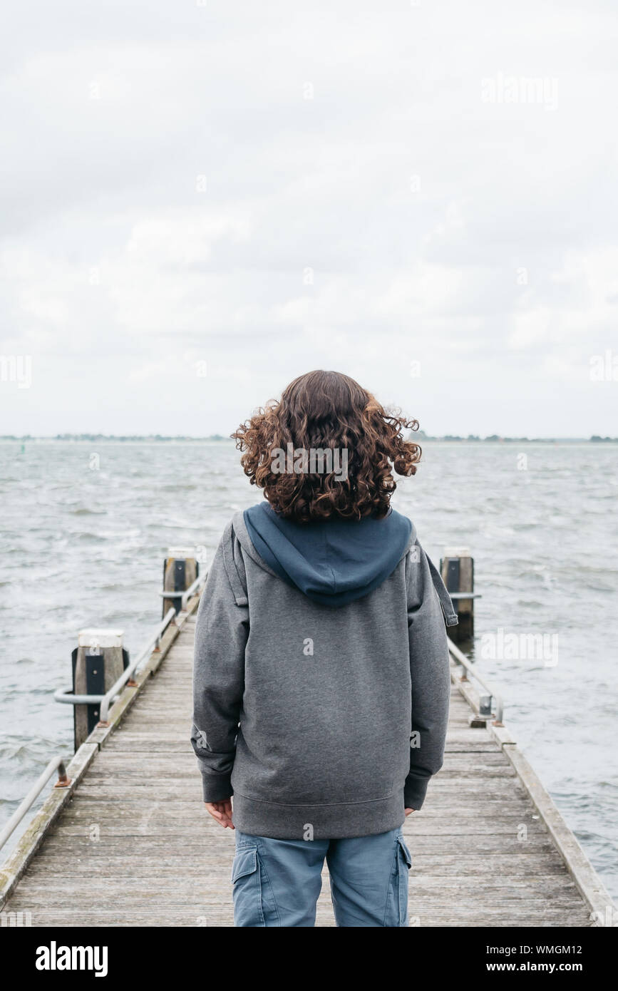 Young man standing jetty hi-res stock photography and images - Alamy