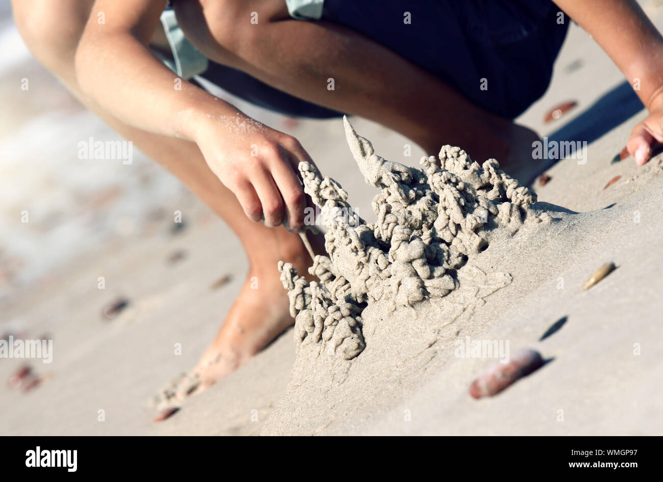 Boy building sandcastle on beach hi-res stock photography and images ...