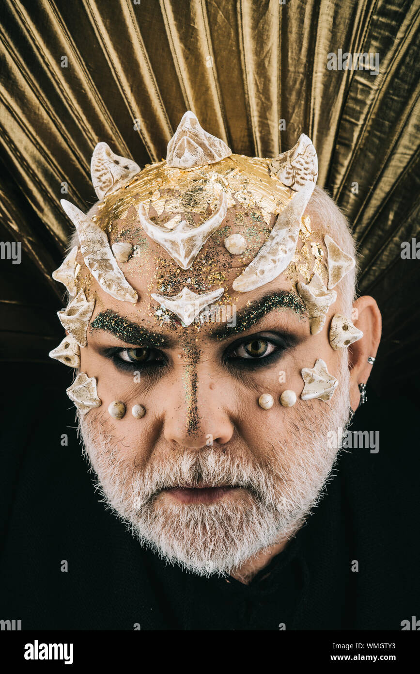 Demon head wearing golden collar appearing from darkness, nightmare ...