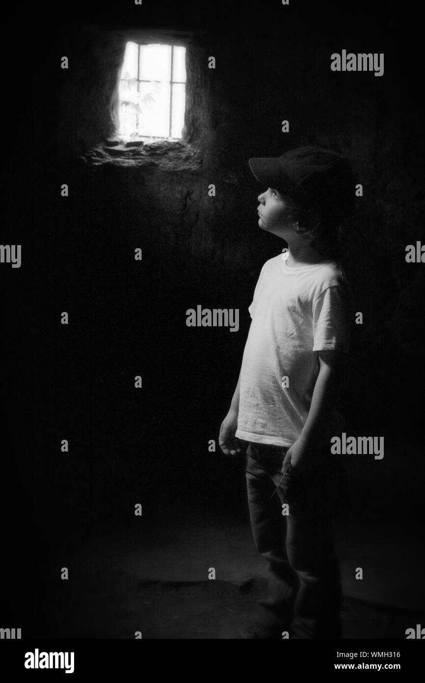 Boy looking in window Black and White Stock Photos & Images - Alamy