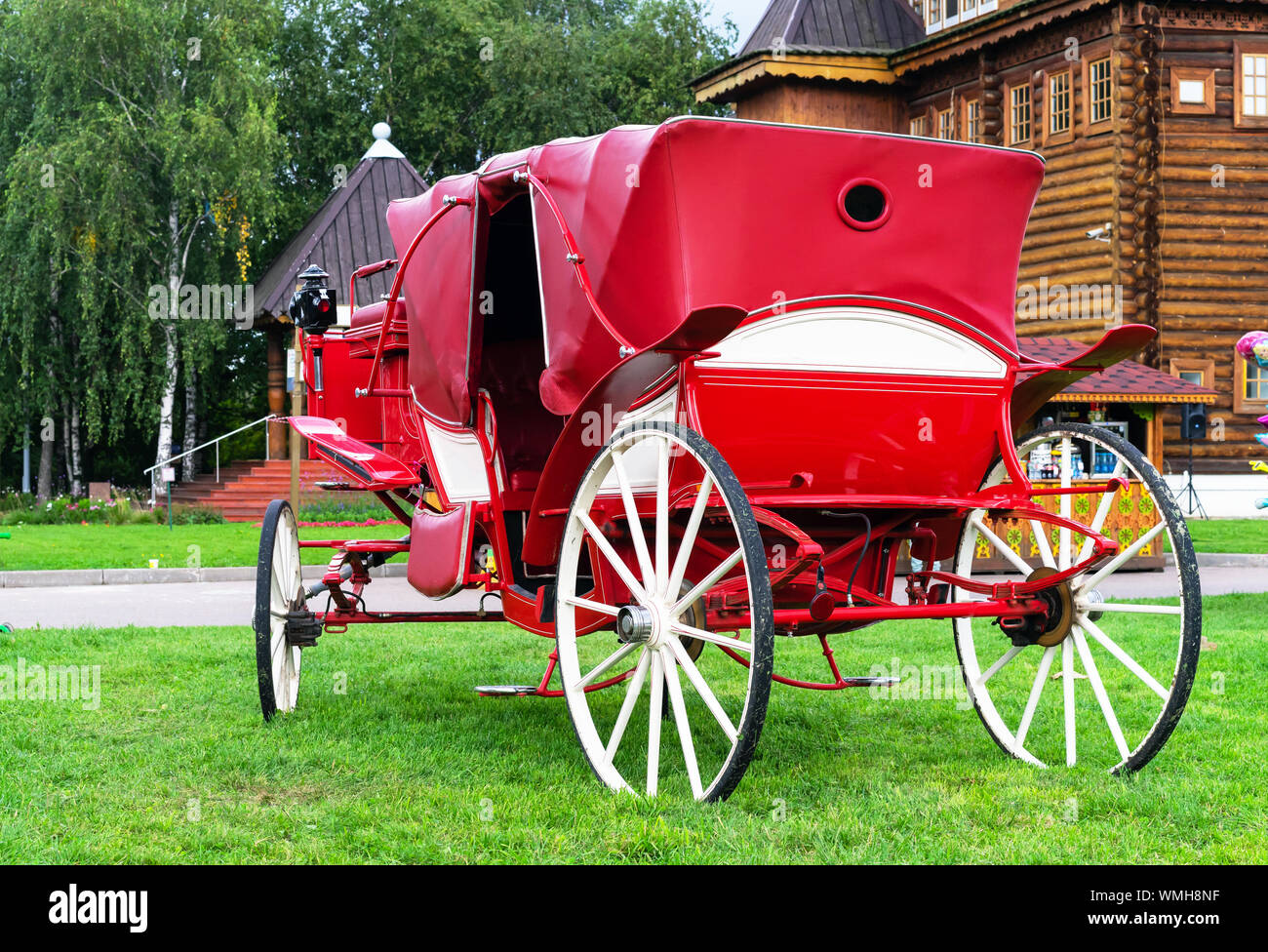 Red historical carriage on green grass Stock Photo - Alamy