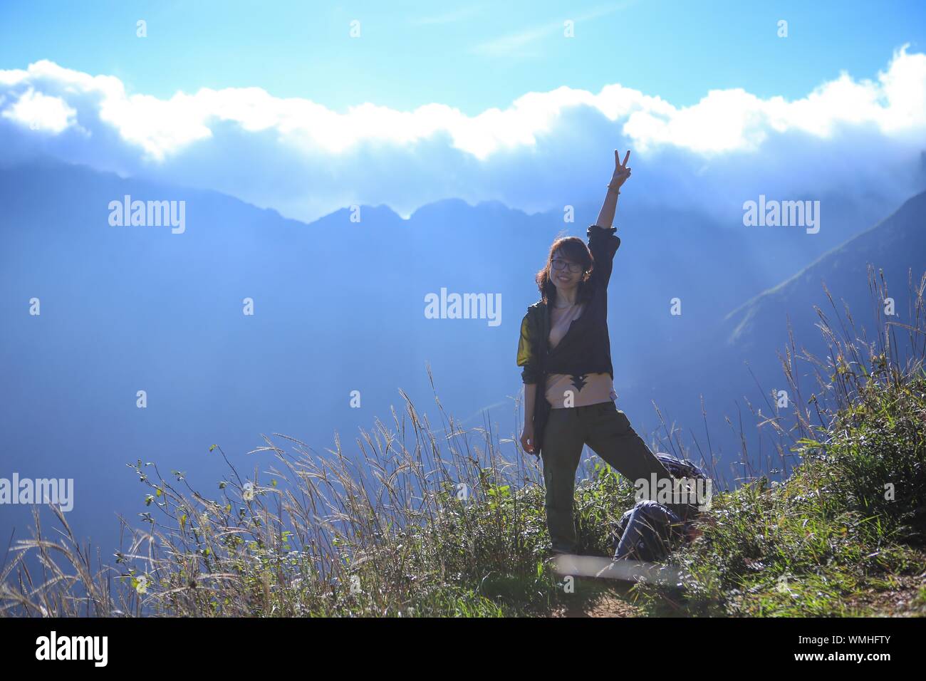 Asian woman gesturing peace sign hi-res stock photography and images ...