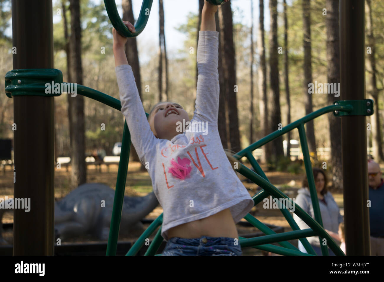 Girl climbing on monkey bars hi-res stock photography and images - Alamy