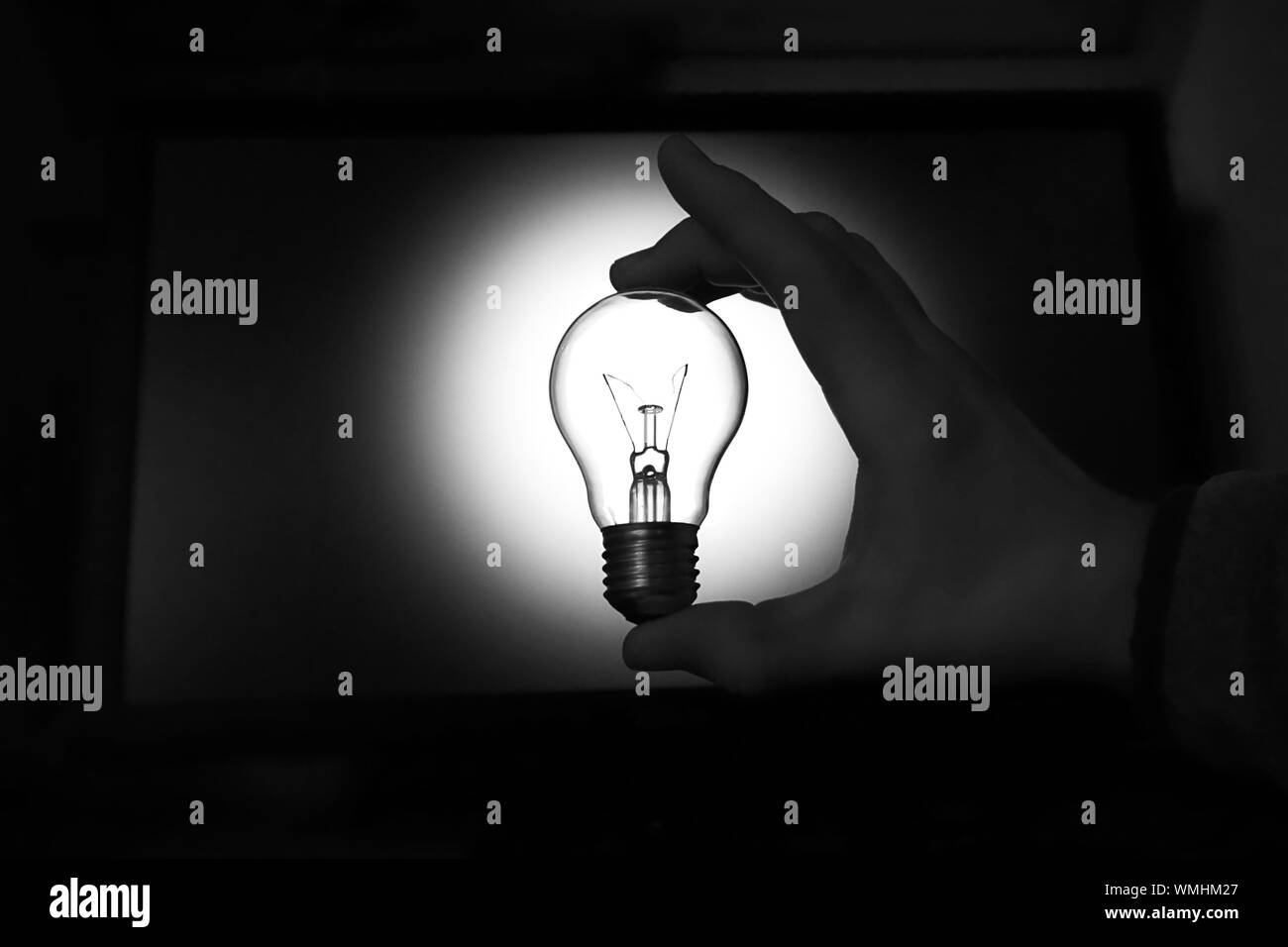 Hand holding glowing light bulb hi-res stock photography and images - Alamy