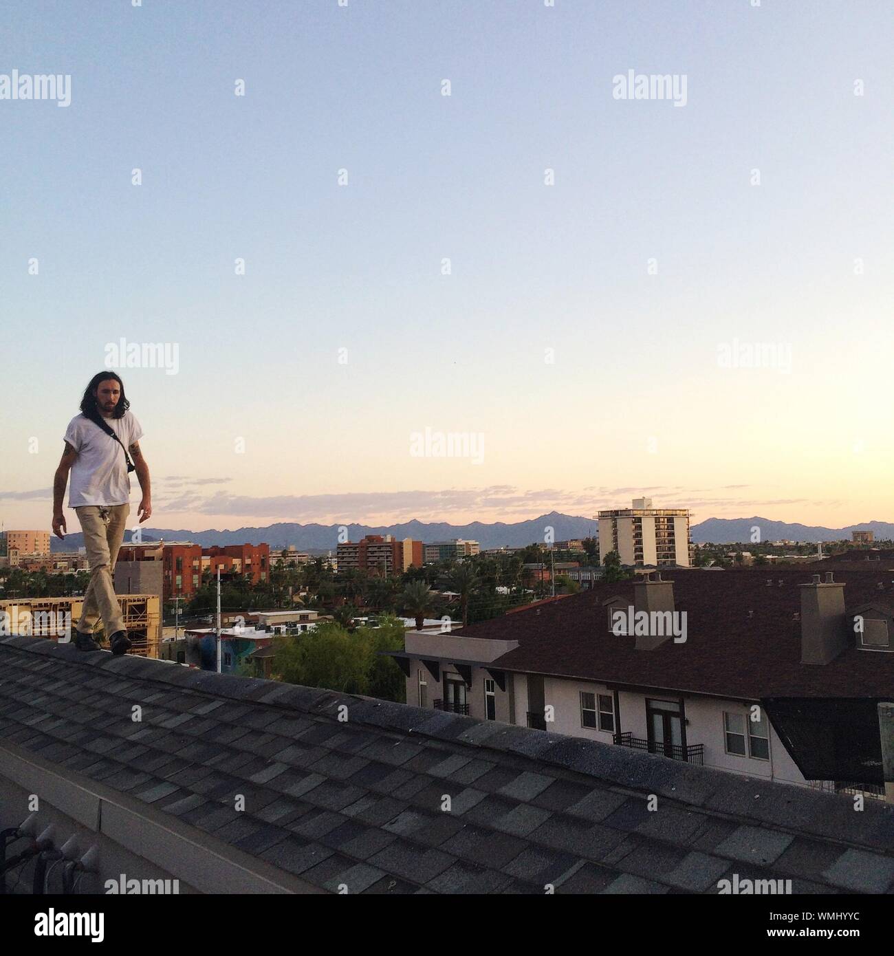 Man on rooftop hi-res stock photography and images - Alamy