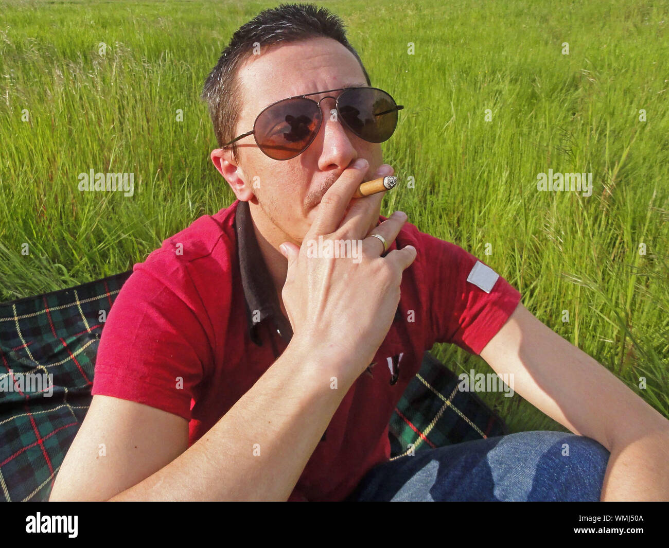Young Man Smoking Cigar Outdoors High Resolution Stock Photography and ...