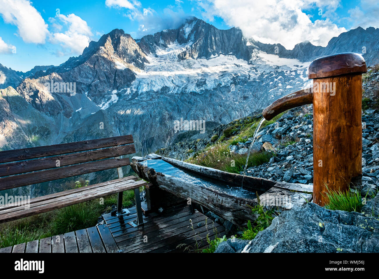 Fountain of flowing water in the Italian alps Stock Photo - Alamy