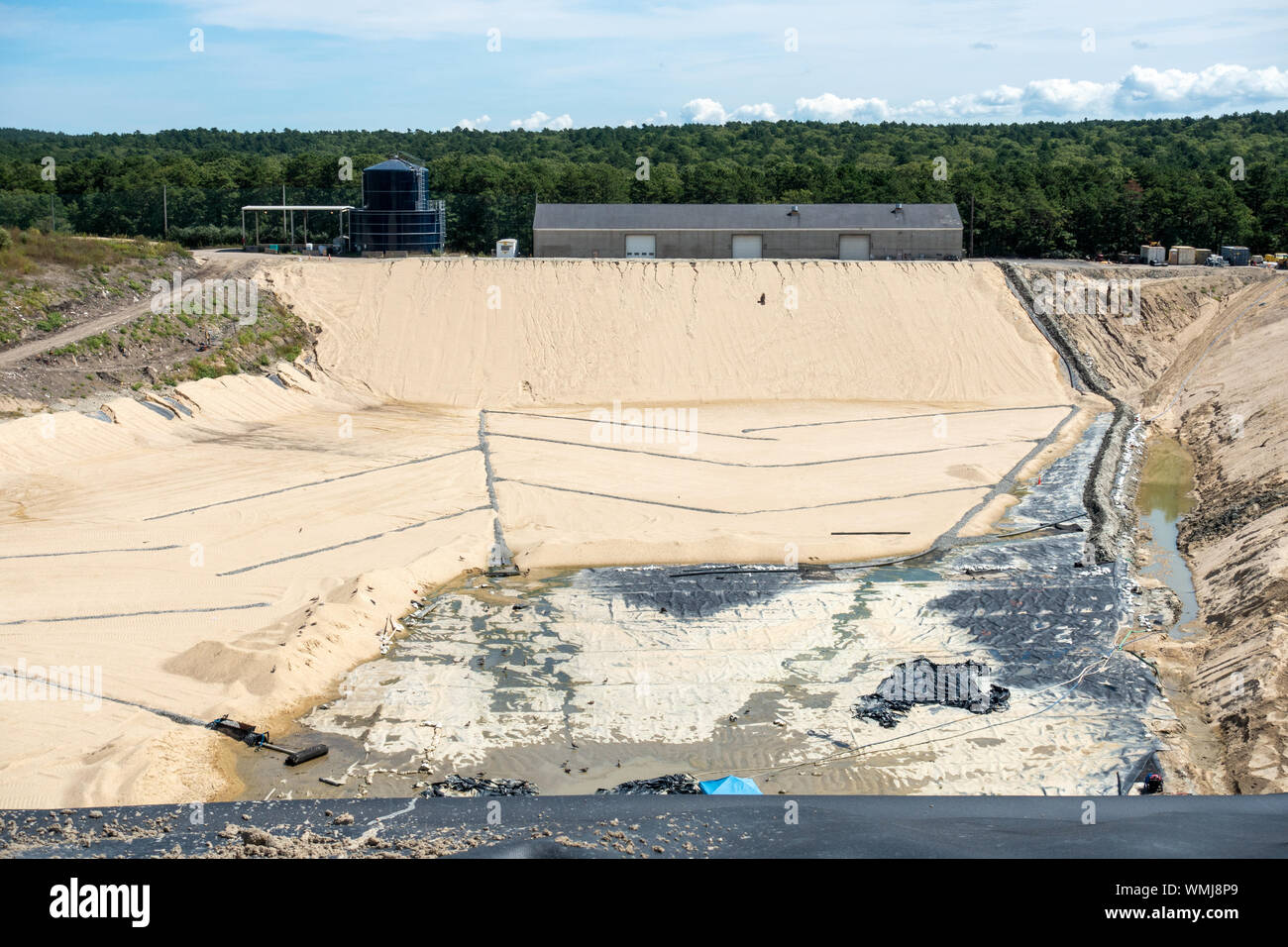 New waste disposal cell being built at landfill with big hole excavated ...