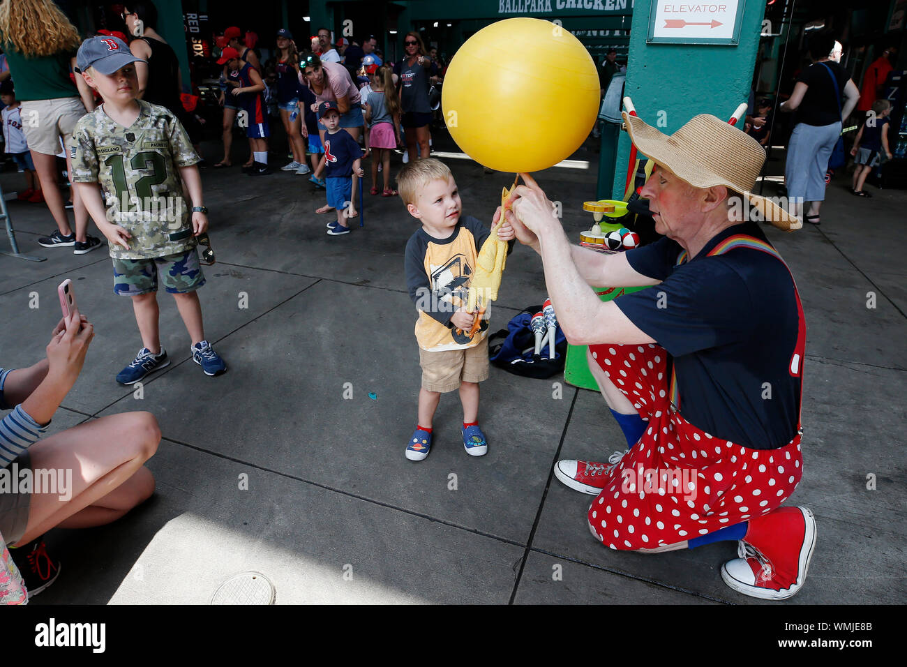 Street performer clown young boy at Fenway Park, Boston Massachusetts ...