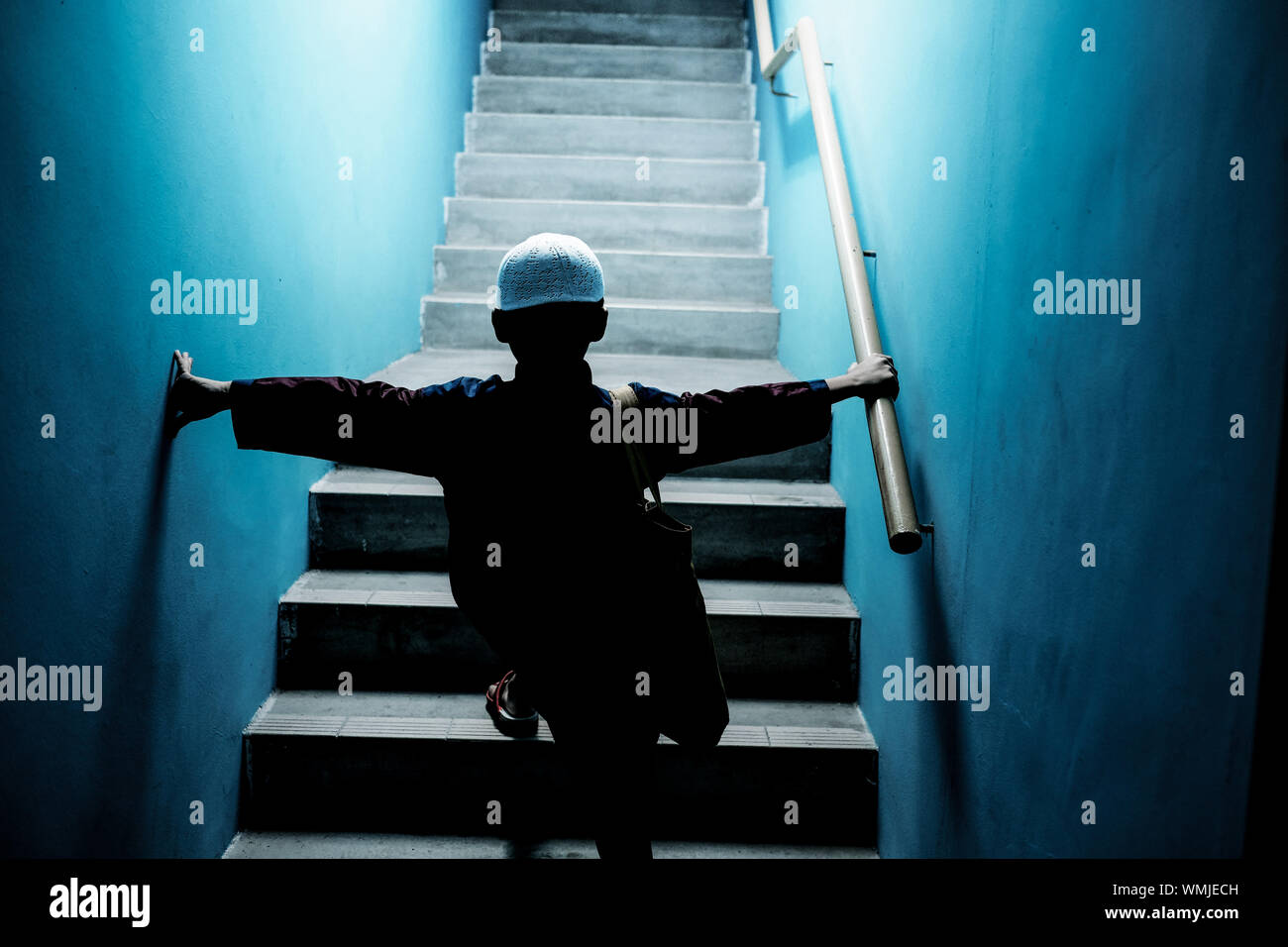 Rear View Of Boy Walking On Steps Stock Photo - Alamy