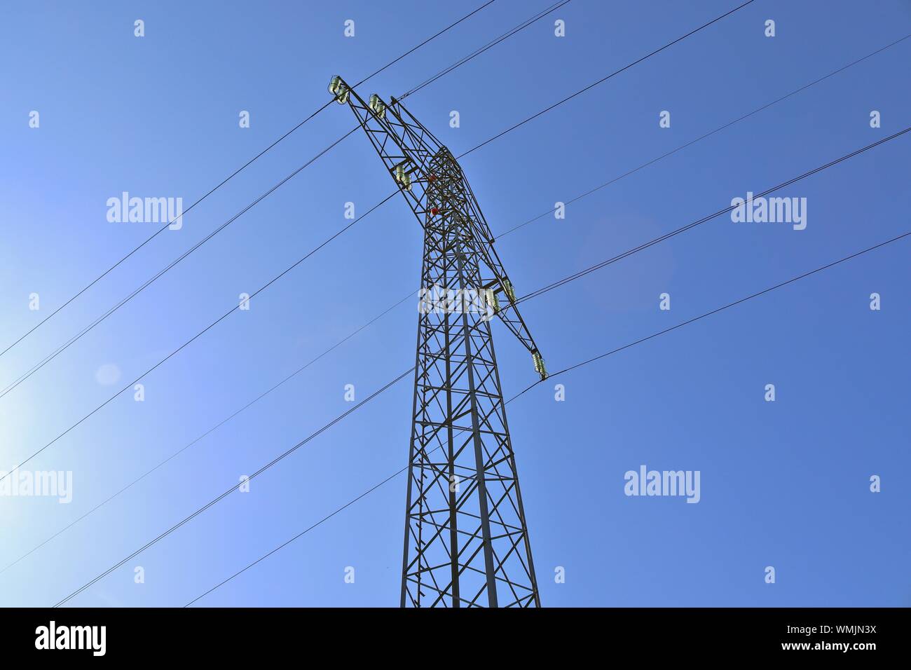 Close up view on a steel power pylon with high voltage power lines ...