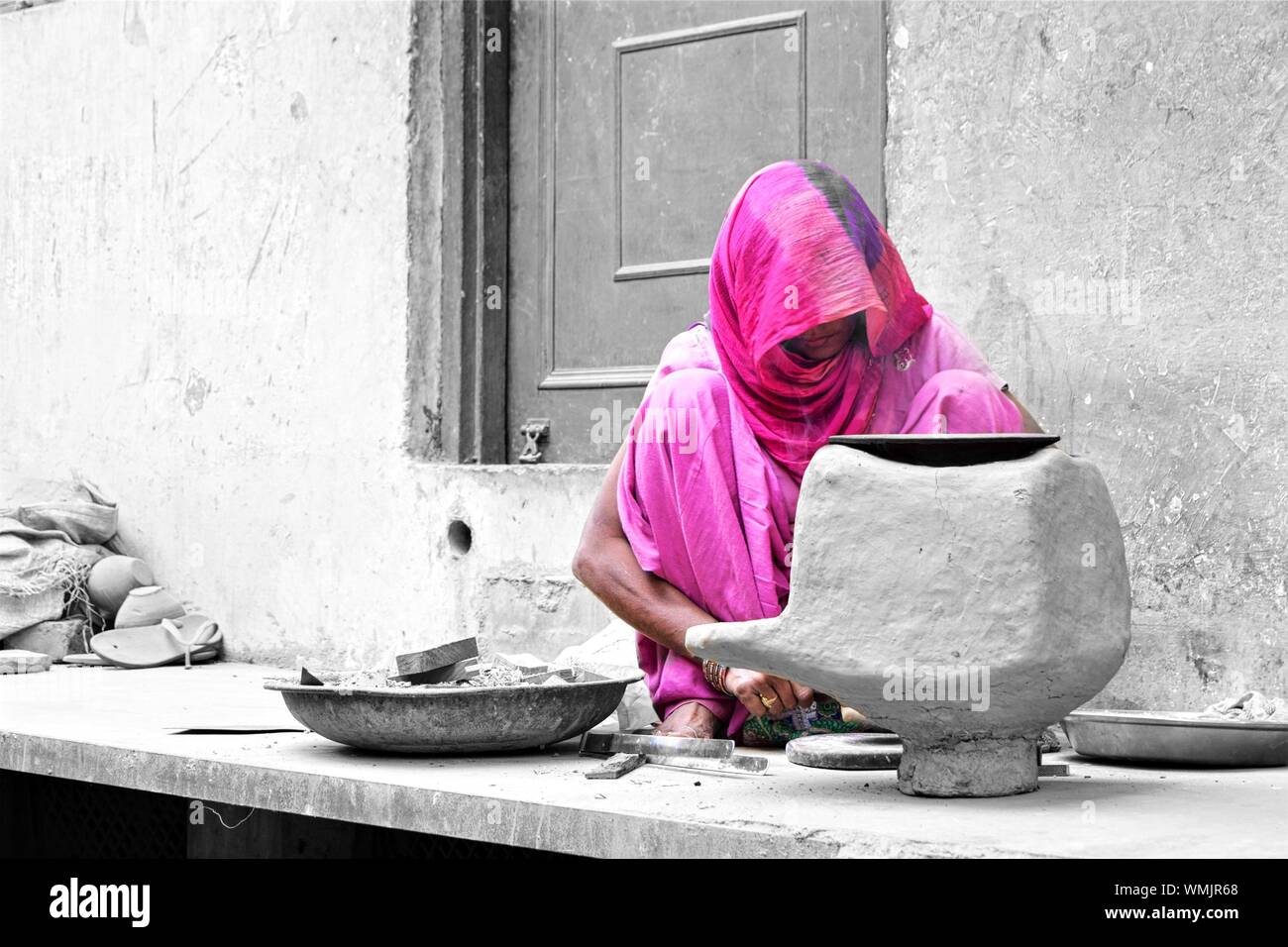 A poor woman cooking breads Stock Photo - Alamy