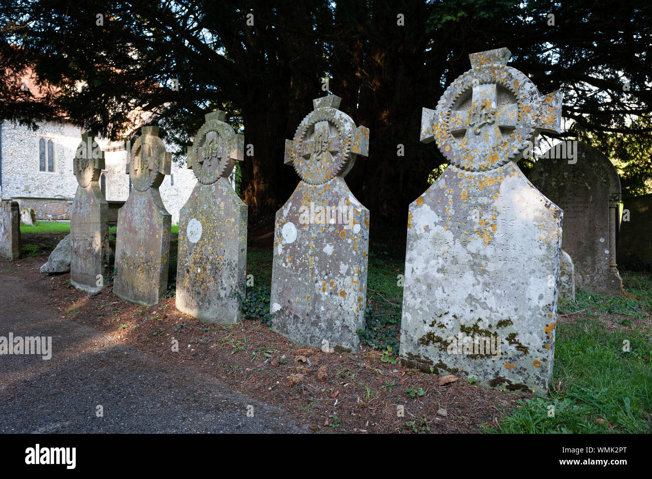 Row of graveyard headstones topped with a Celtic cross at the Anglo ...