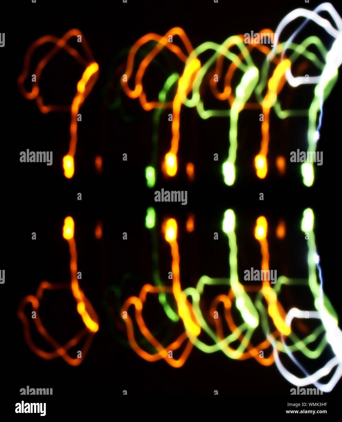 Colorful light streaks glowing on black background Stock Photo - Alamy