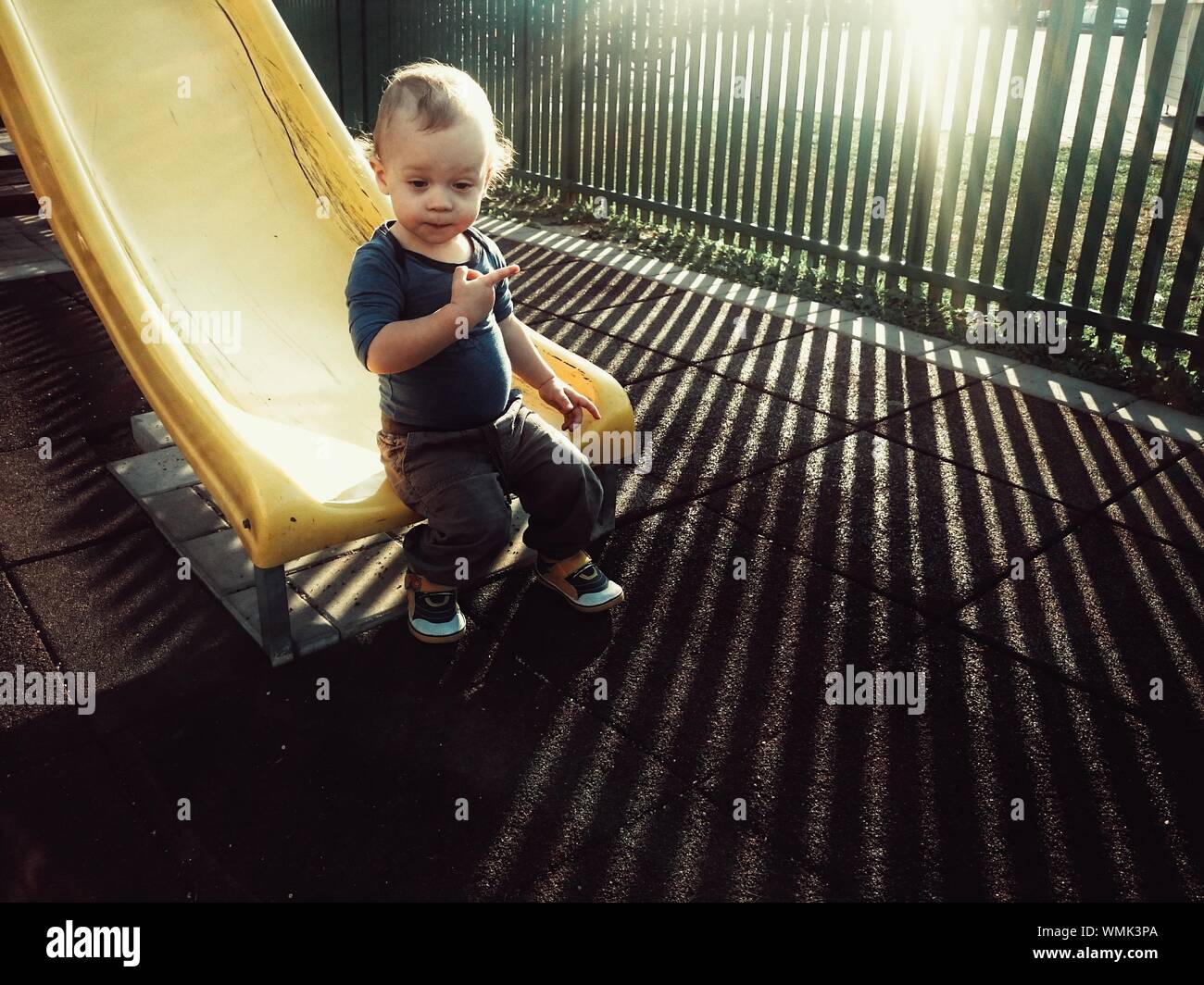 Children standing on playground slide hi-res stock photography and ...